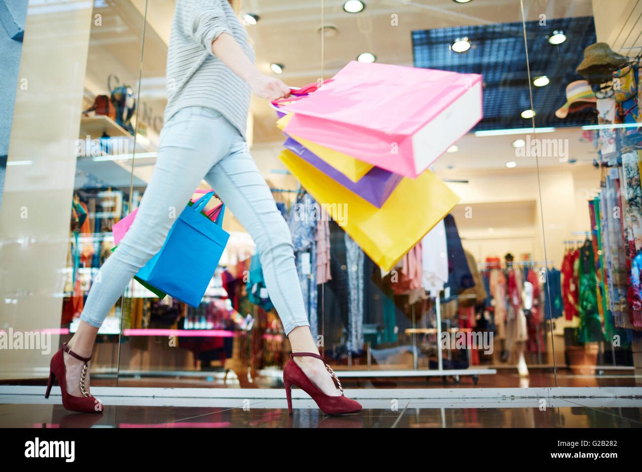 Female walking in shopping mall Stock Photo - Alamy