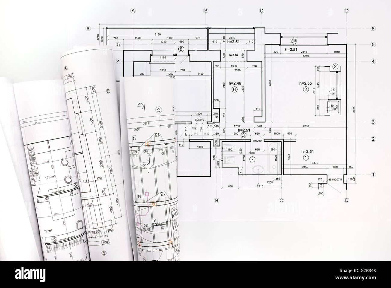 architects workspace with rolled construction plans and blueprints ...