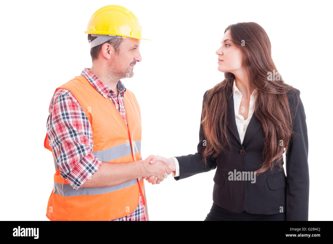 Builder constructor and business woman shaking hands as partnership and ...