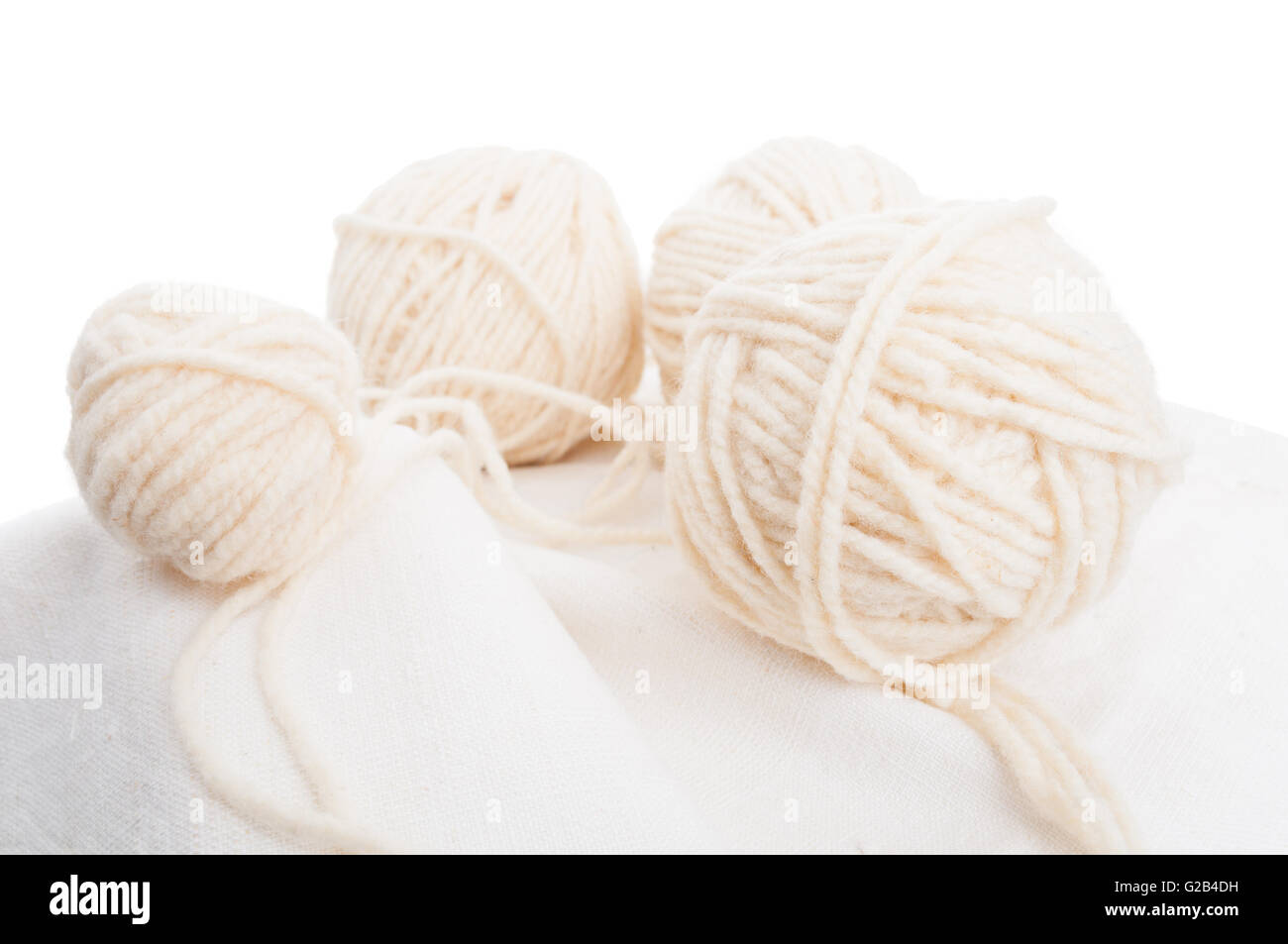Balls of soft wool on cotton fabric isolated on white background Stock ...
