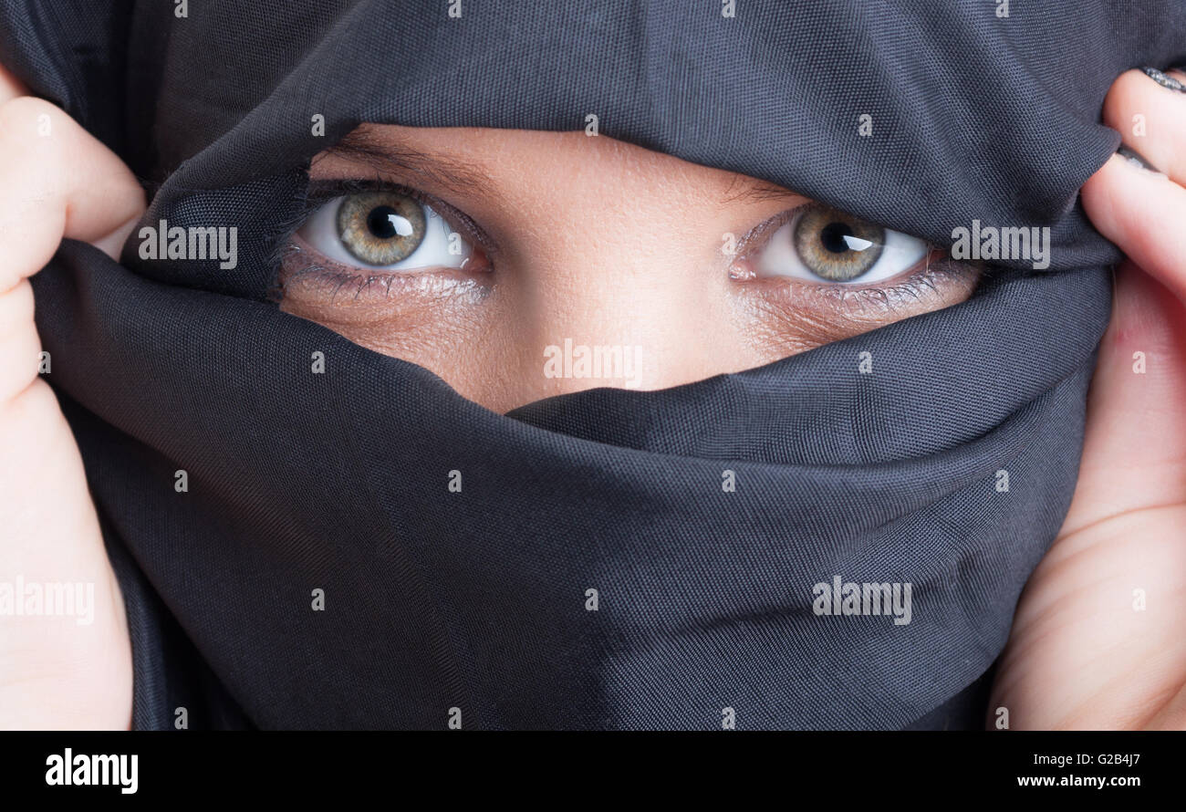 Close-up with beautiful islamic woman eyes and face covered by black ...