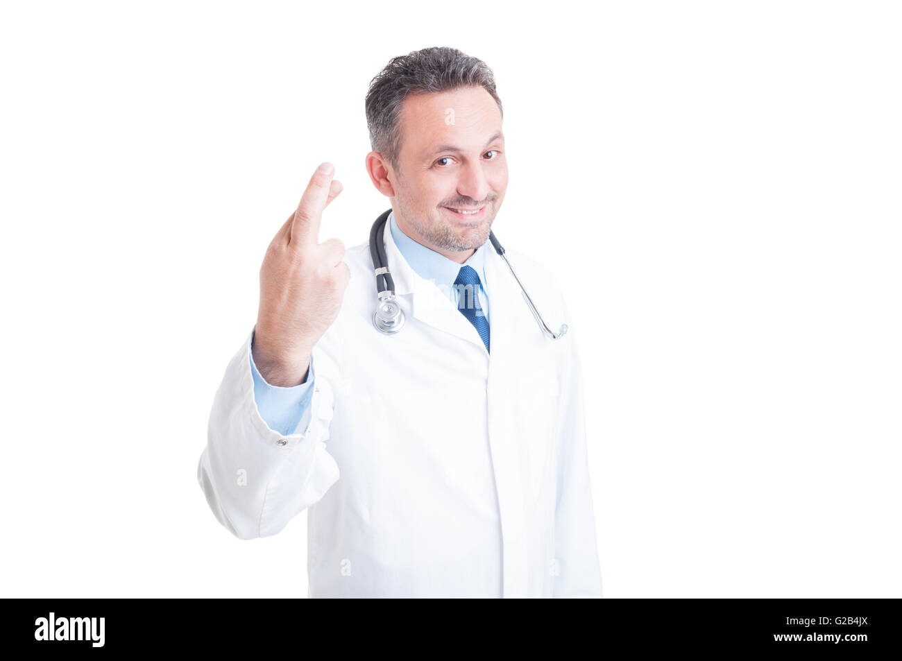 Friendly doctor making good luck gesture with crossed fingers smiling ...