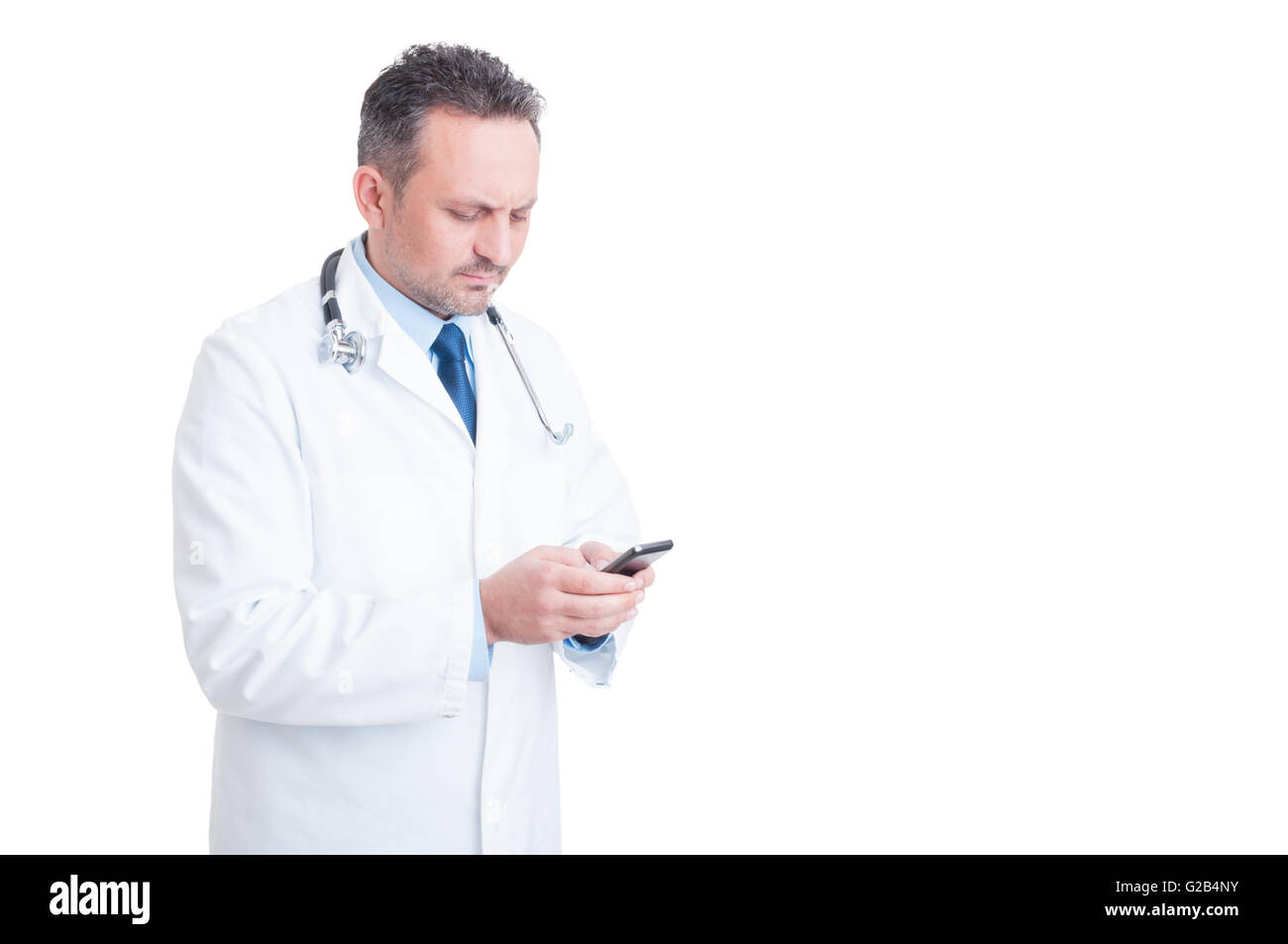 Young and modern doctor or medic texting on smartphone concentrated on ...
