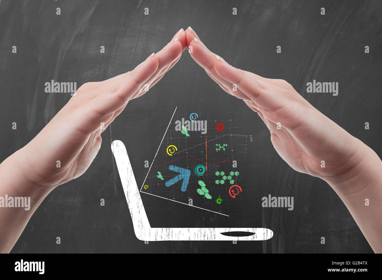 Hands protecting laptop draw on blackboard or school chalk board as ...