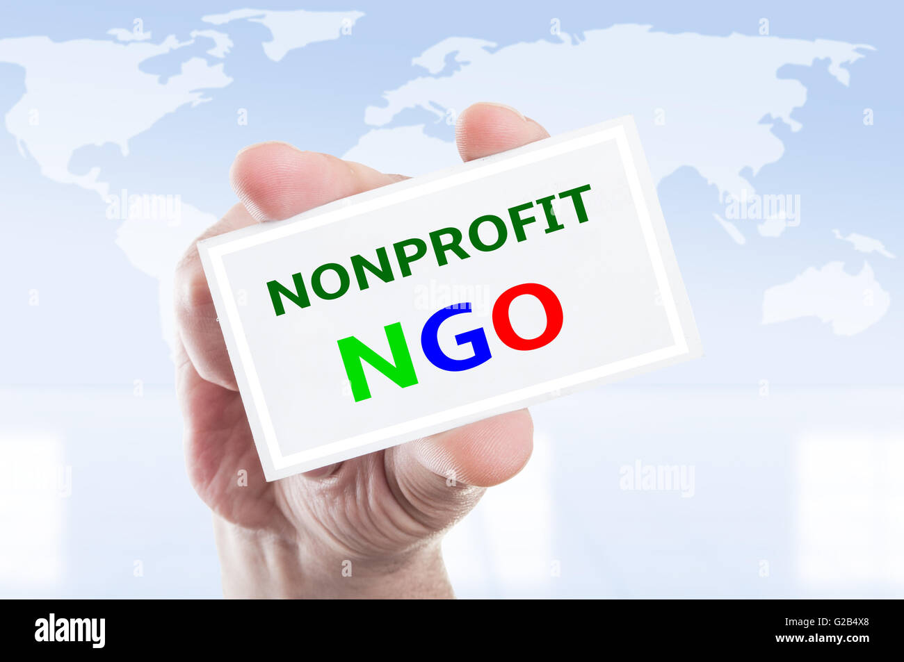 Hand holding nonprofit NGO card concept on world map background Stock ...