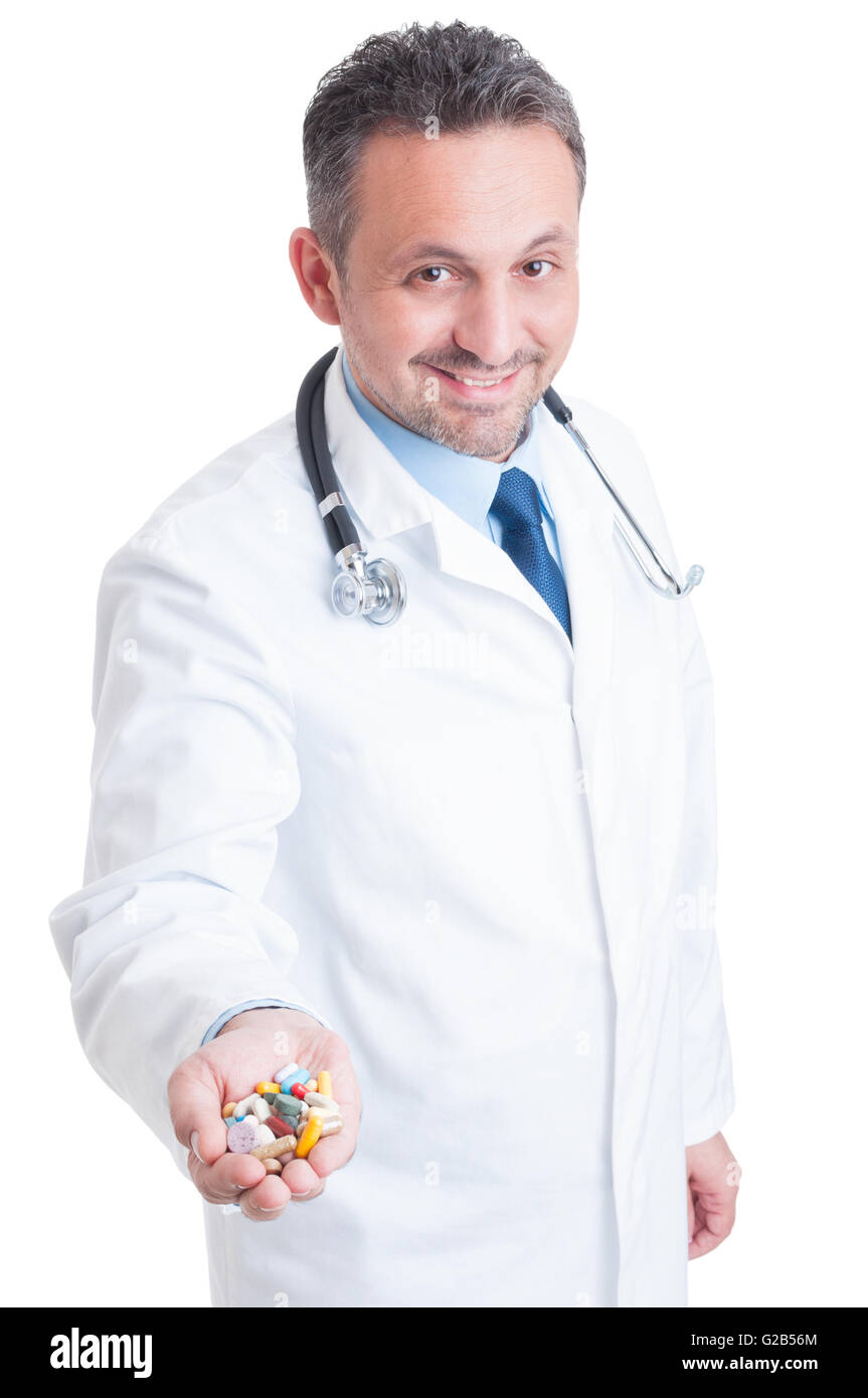 Doctor or medic offering a handful of pills smiling friendly on white ...