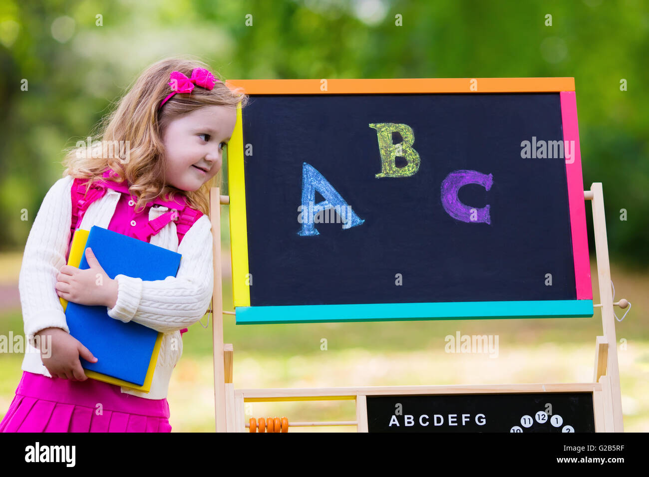 Child happy to be back to school. Funny little preschooler girl with ...