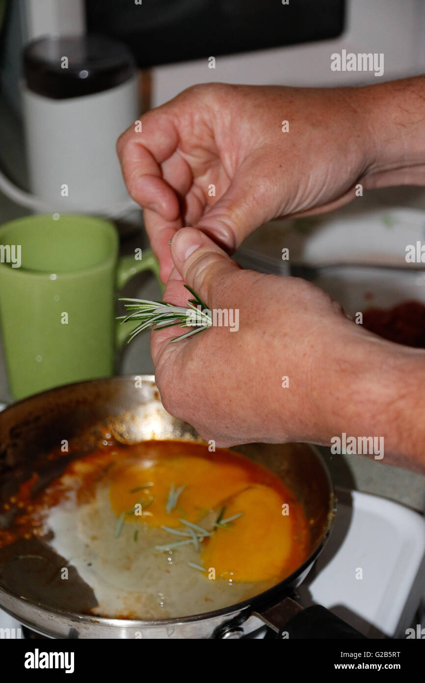 Young man cooking eggs hi-res stock photography and images - Alamy