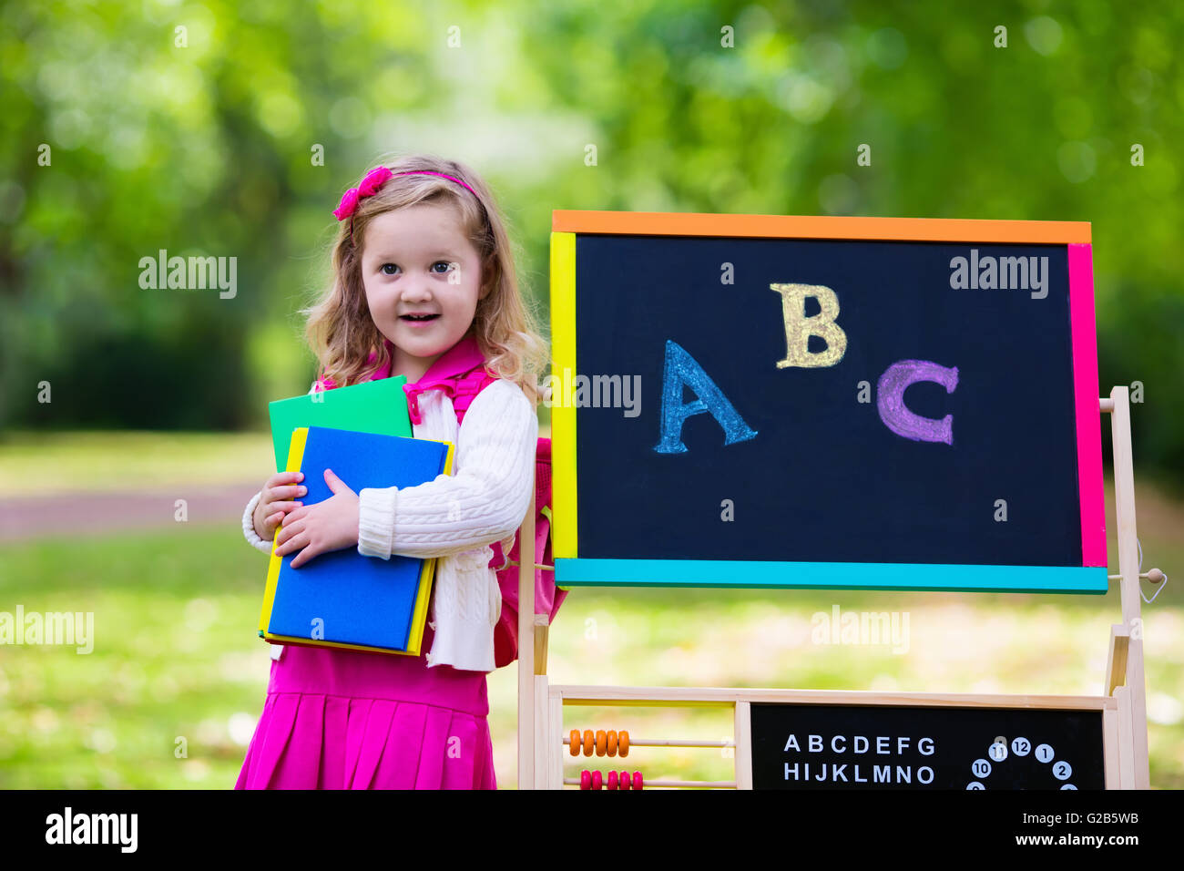 Child happy to be back to school. Funny little preschooler girl with ...