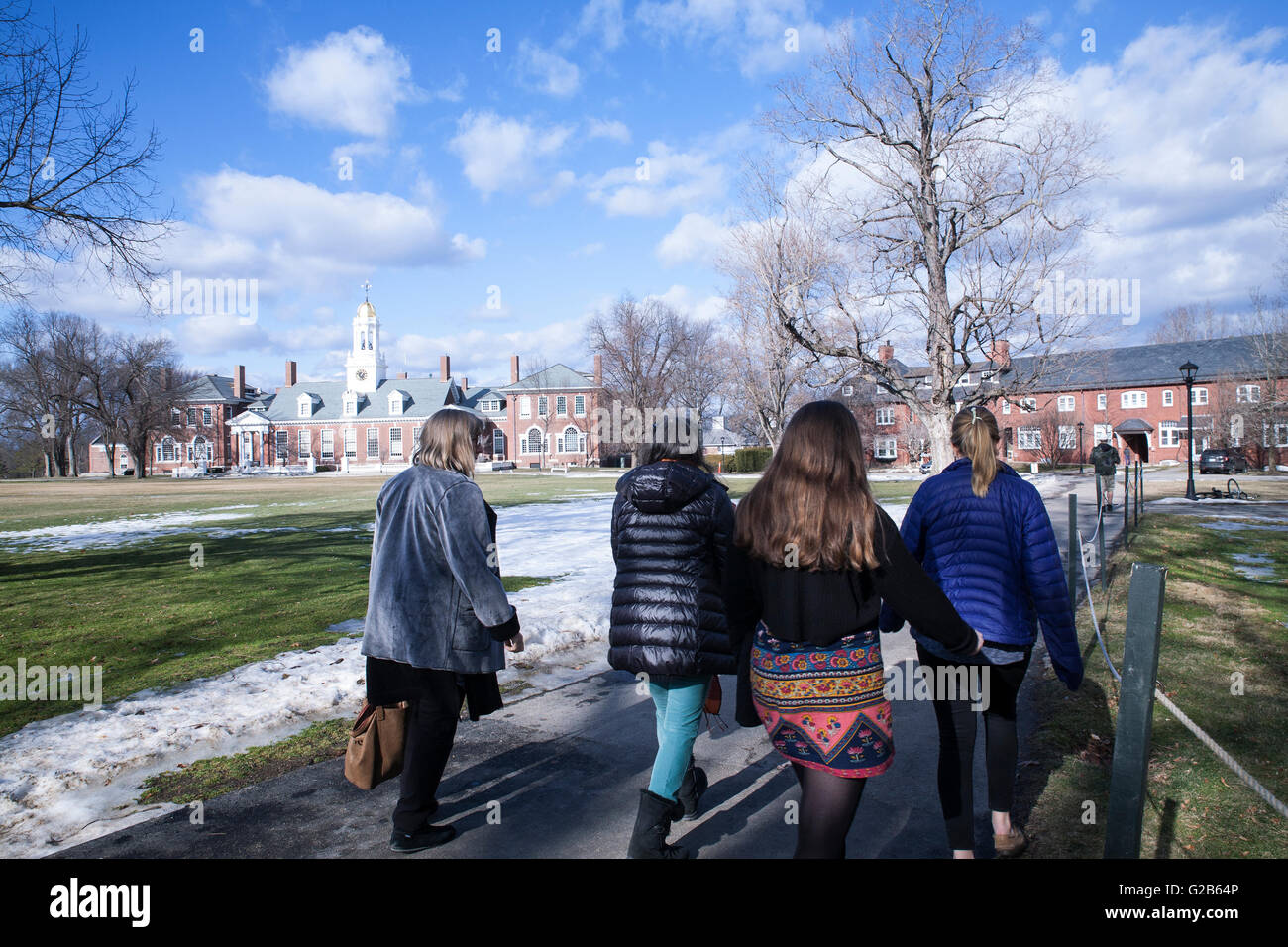 Women walk towards The Schoolhouse, the main building at Groton School ...