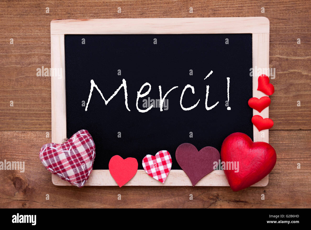 Blackboard With Textile Hearts, Text Merci Means Thank You Stock Photo ...