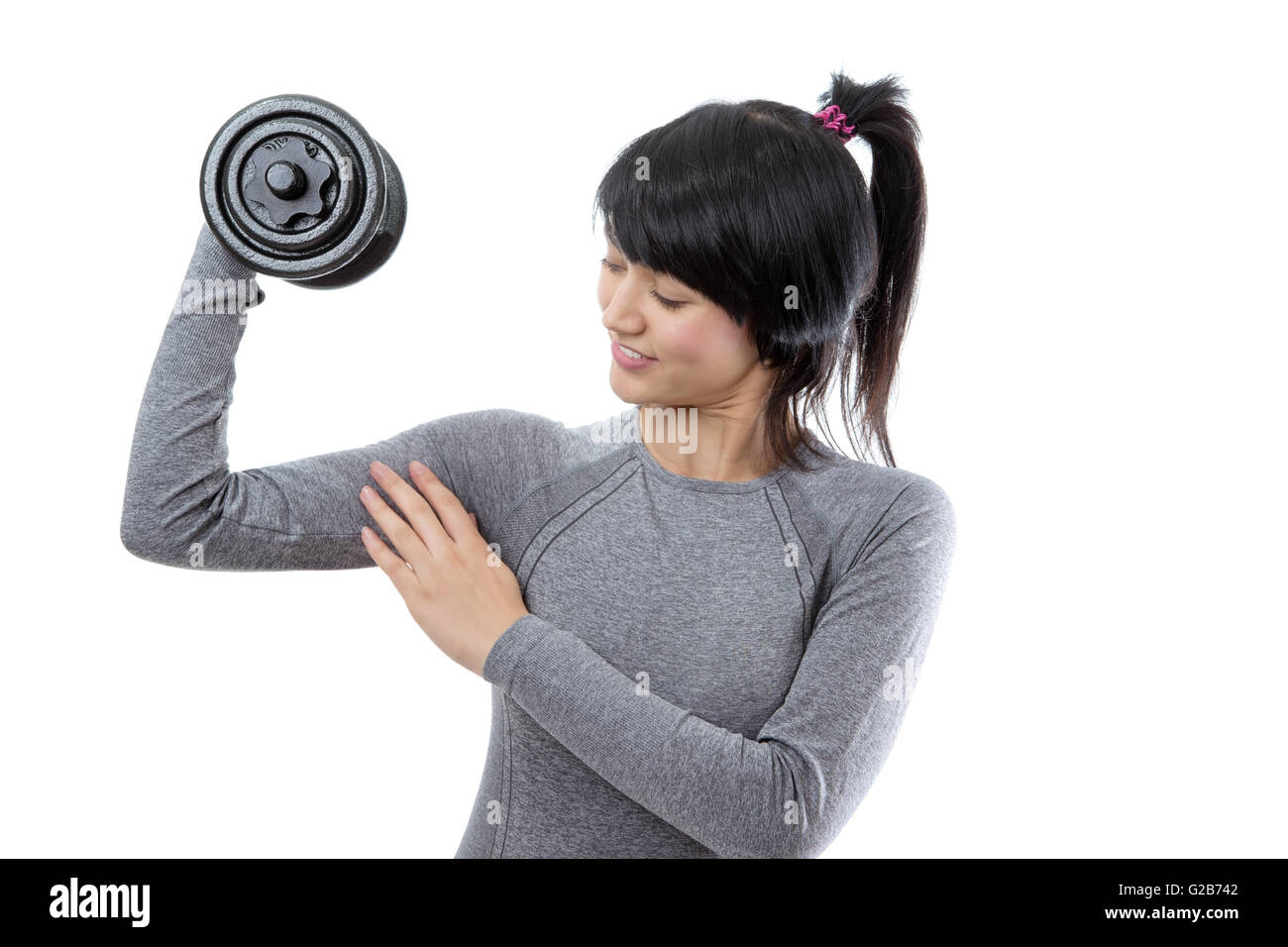 Upper body shot of a slim young female fitness model, wearing a long ...