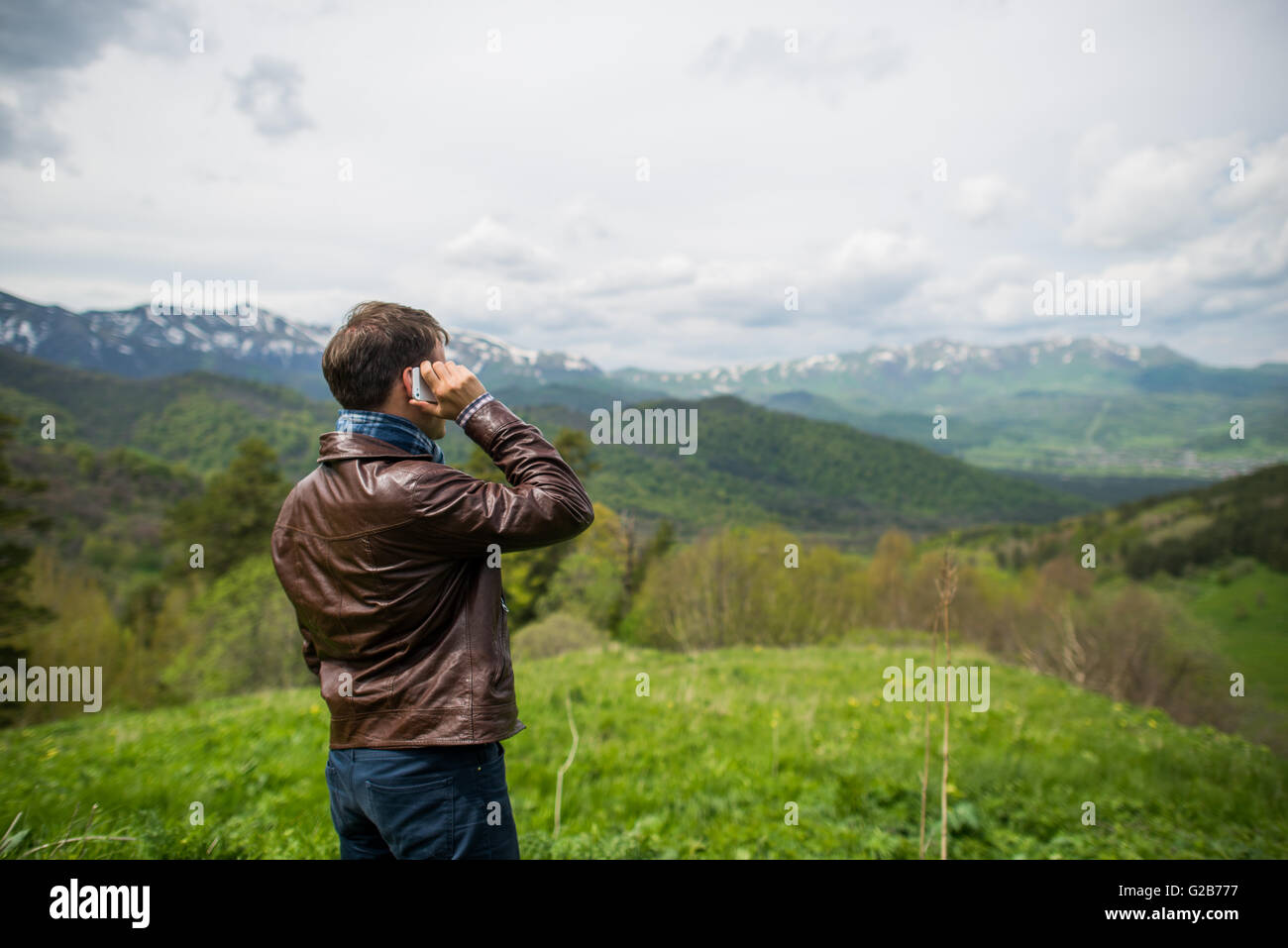 Man calling phone on the mountain Stock Photo - Alamy