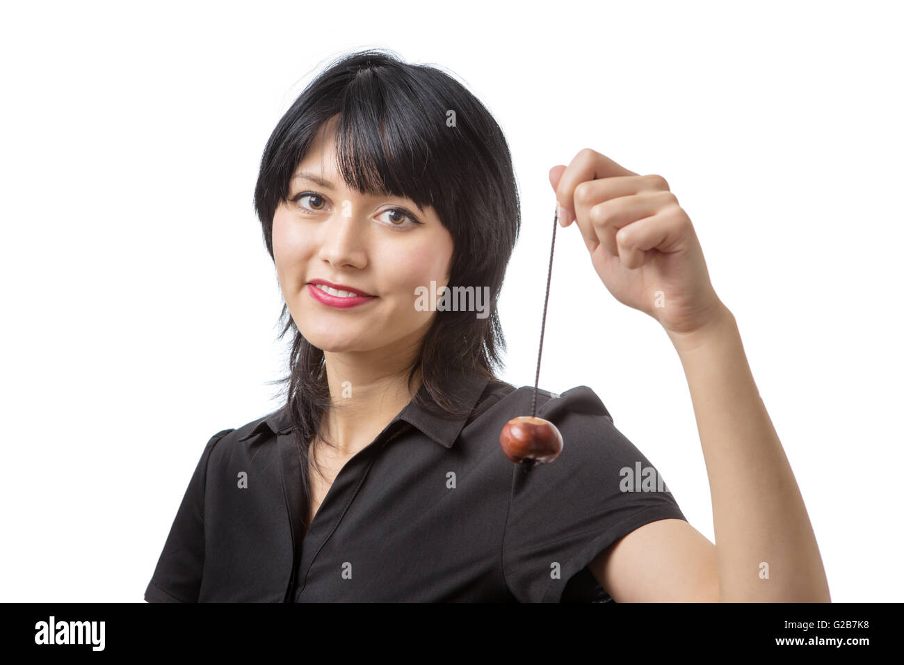 happy business model with a conker on a string held up in front of her ...