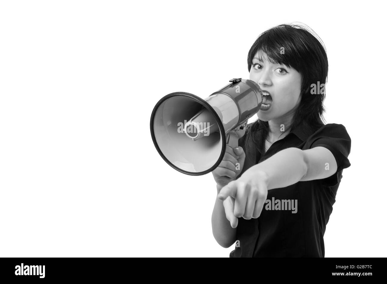 Front view of a business woman using a megaphone raised up to her mouth ...