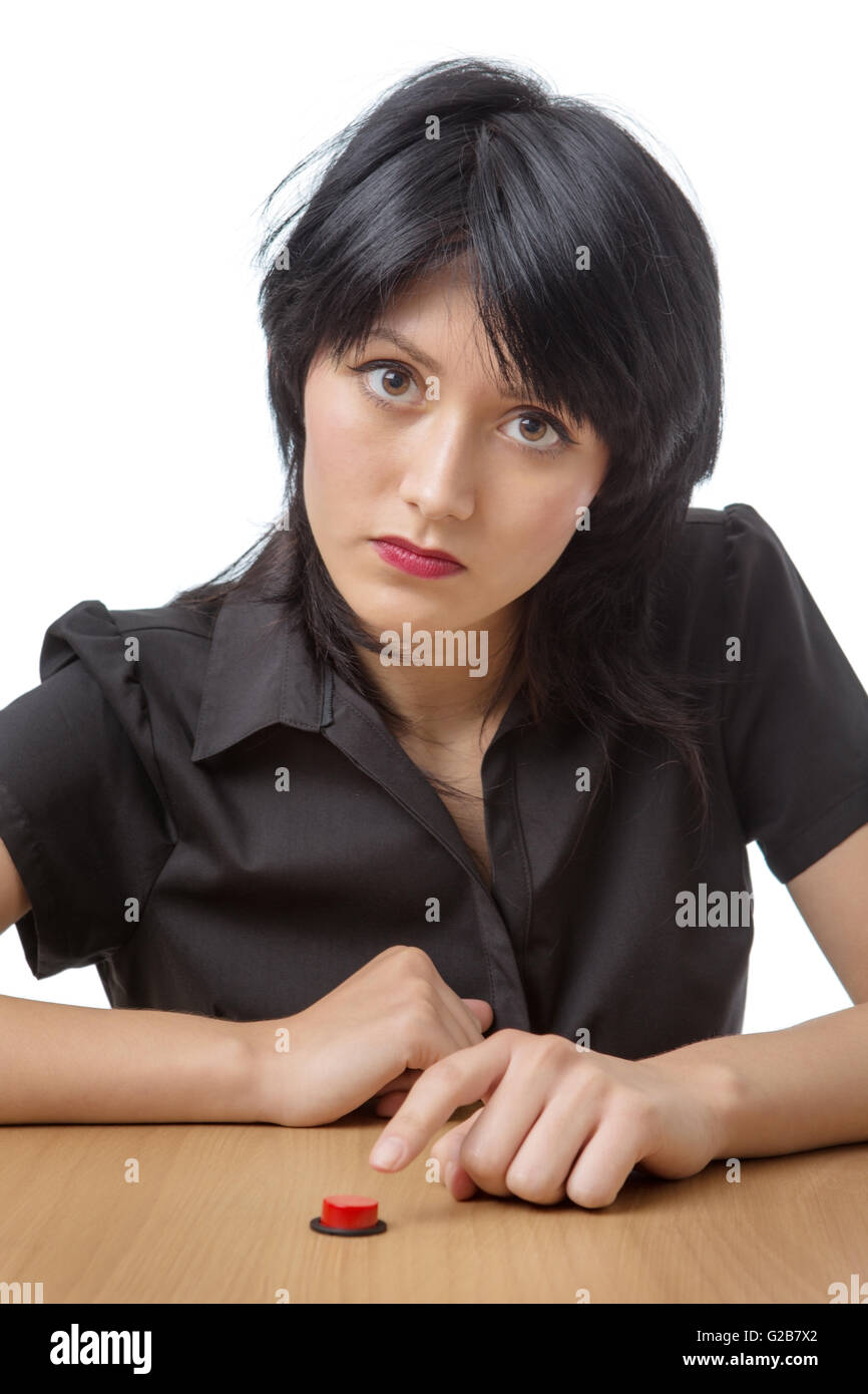 Studio shot of a thoughtful model holding her finger poised above a red ...
