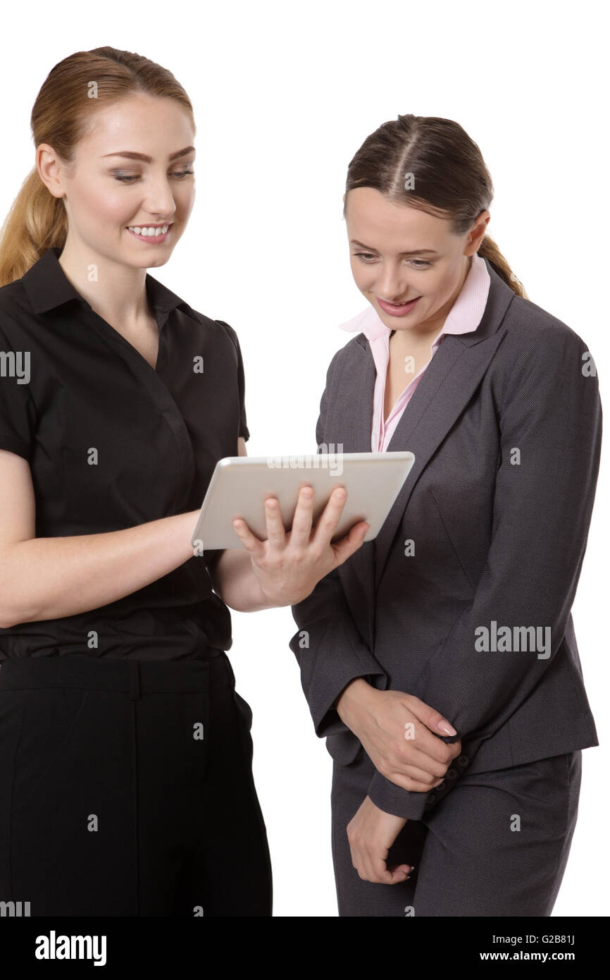 Upper body studio shot of 2 office workers working together on a tablet ...
