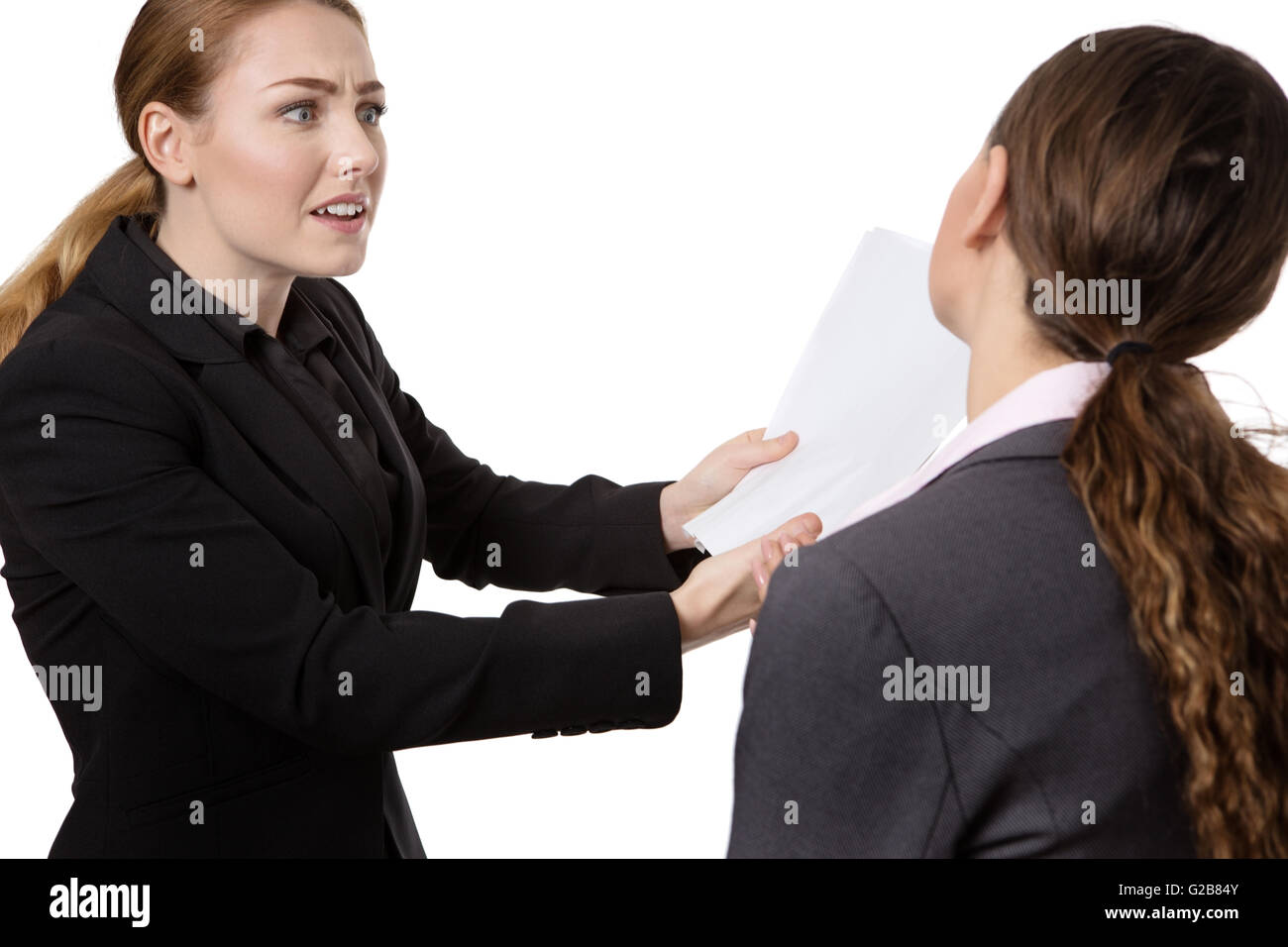 shot of two pretty business women. One is looking very concerned about ...