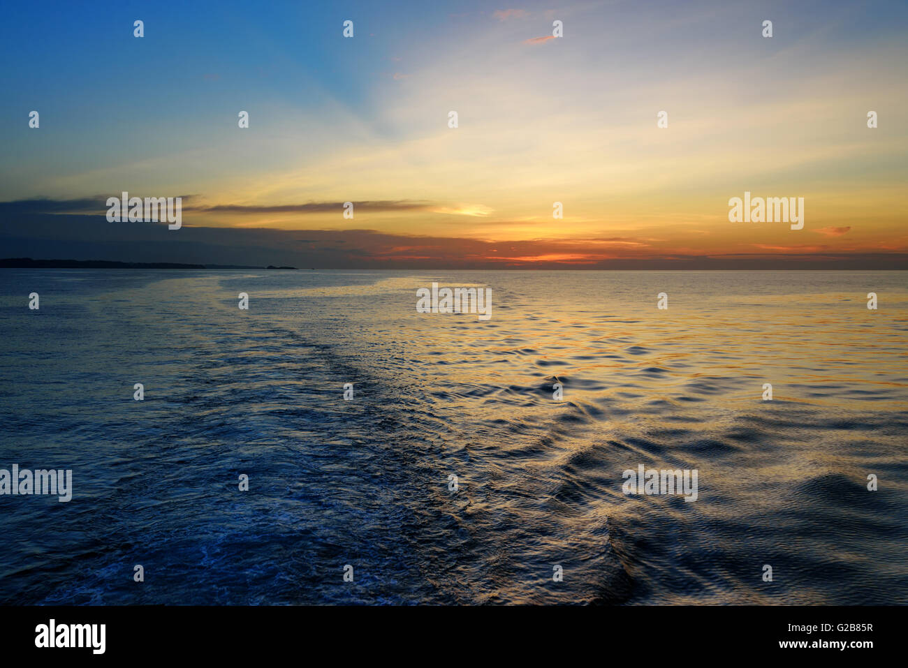 Beautiful sunset at the equator. View from ferry Stock Photo - Alamy