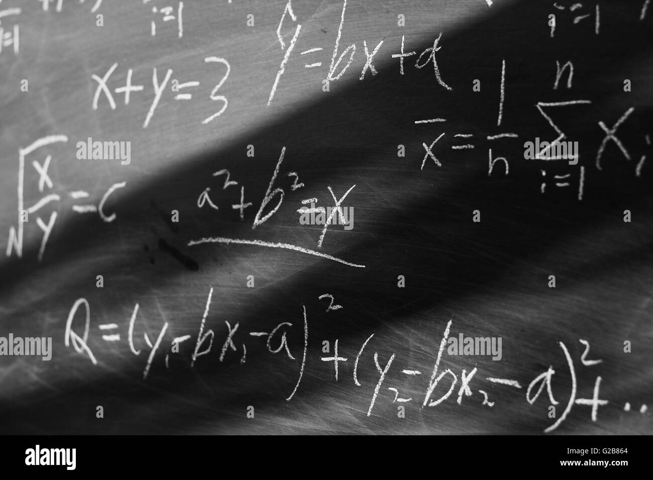 Maths formulas written by white chalk on the blackboard background ...
