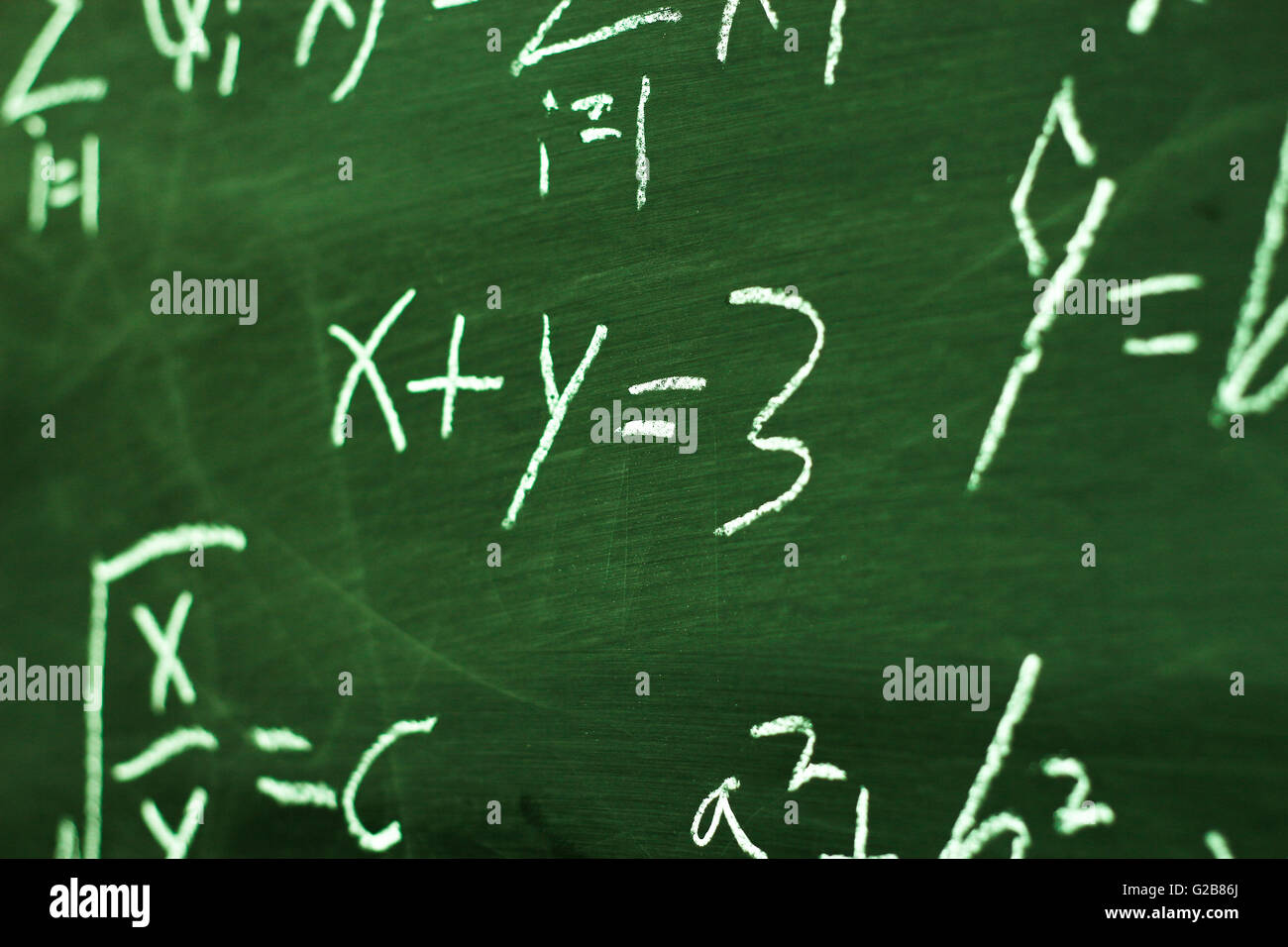 Maths formulas written by white chalk on the chalkboard background ...