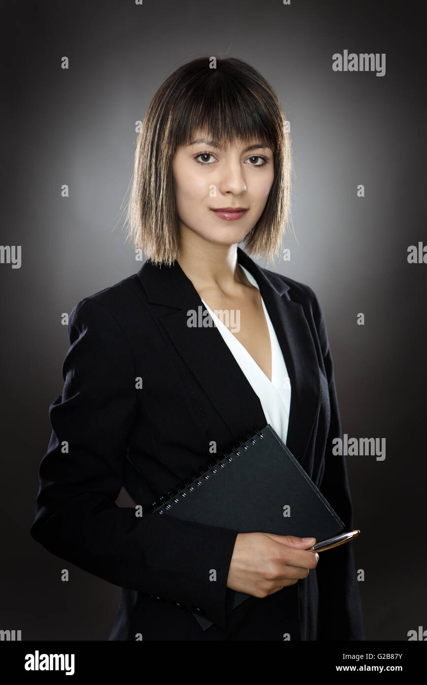 professional looking business woman holding a notebook and pen Stock ...
