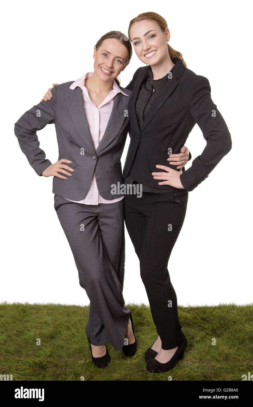 Full length Studio shot of two business models, standing on grass ...