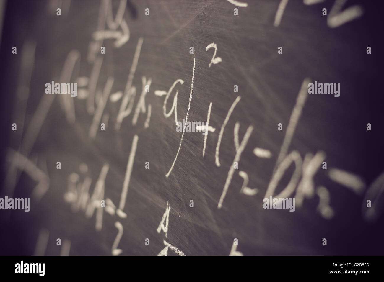 Maths formulas written by white chalk on the blackboard background ...