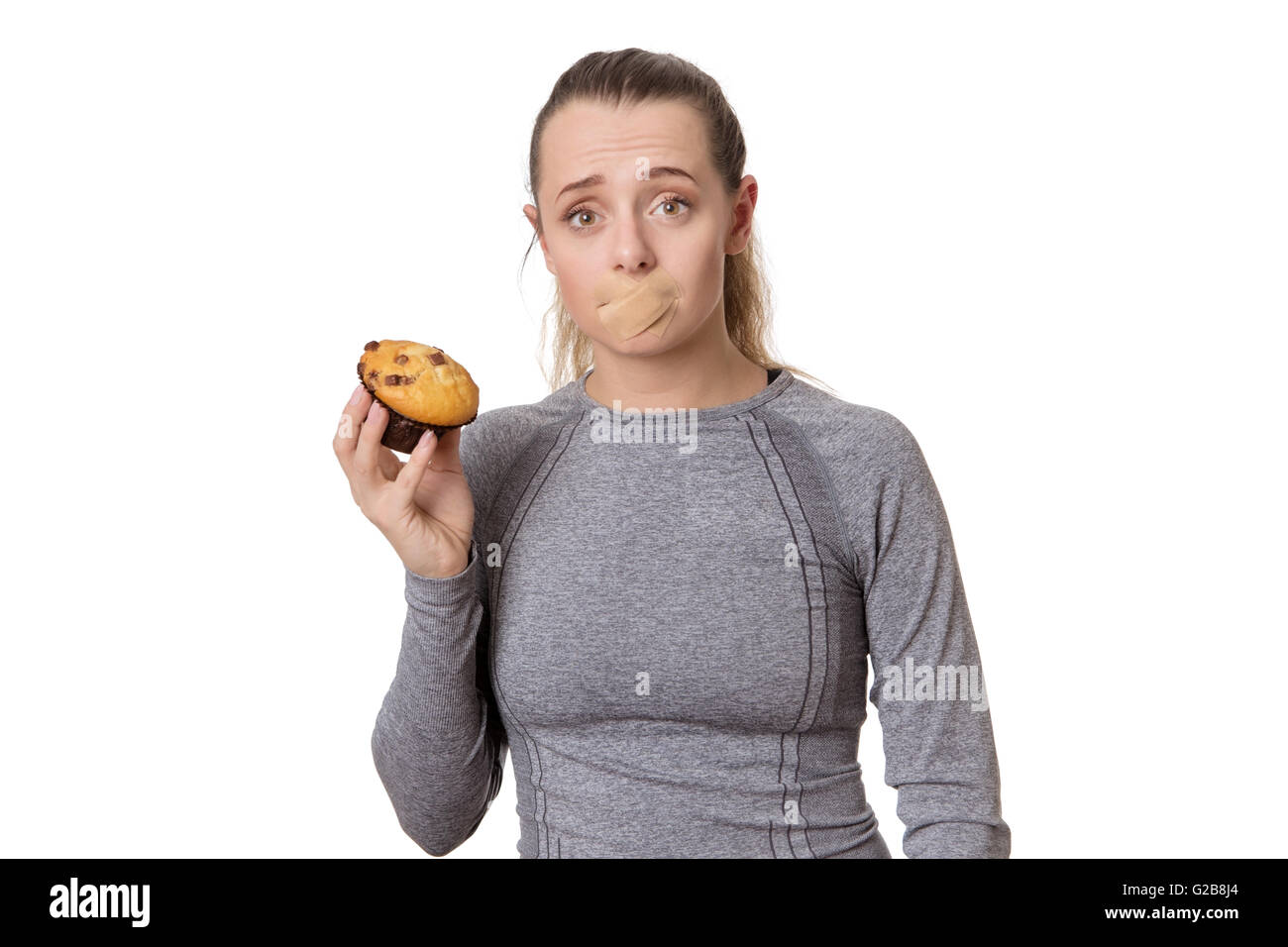 woman with first aid plaster over mouth unable to eat a muffin Stock ...