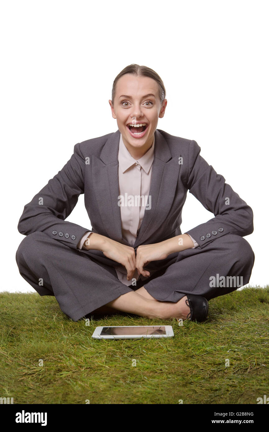 Studio shot of a beautiful business woman, sitting crossed legged on ...