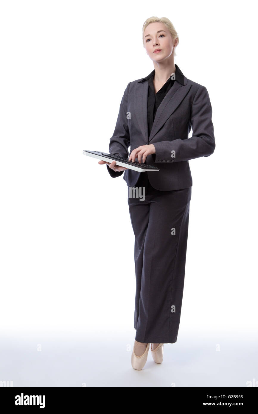 Full length shot of a business ballerina holding a computer keyboard ...