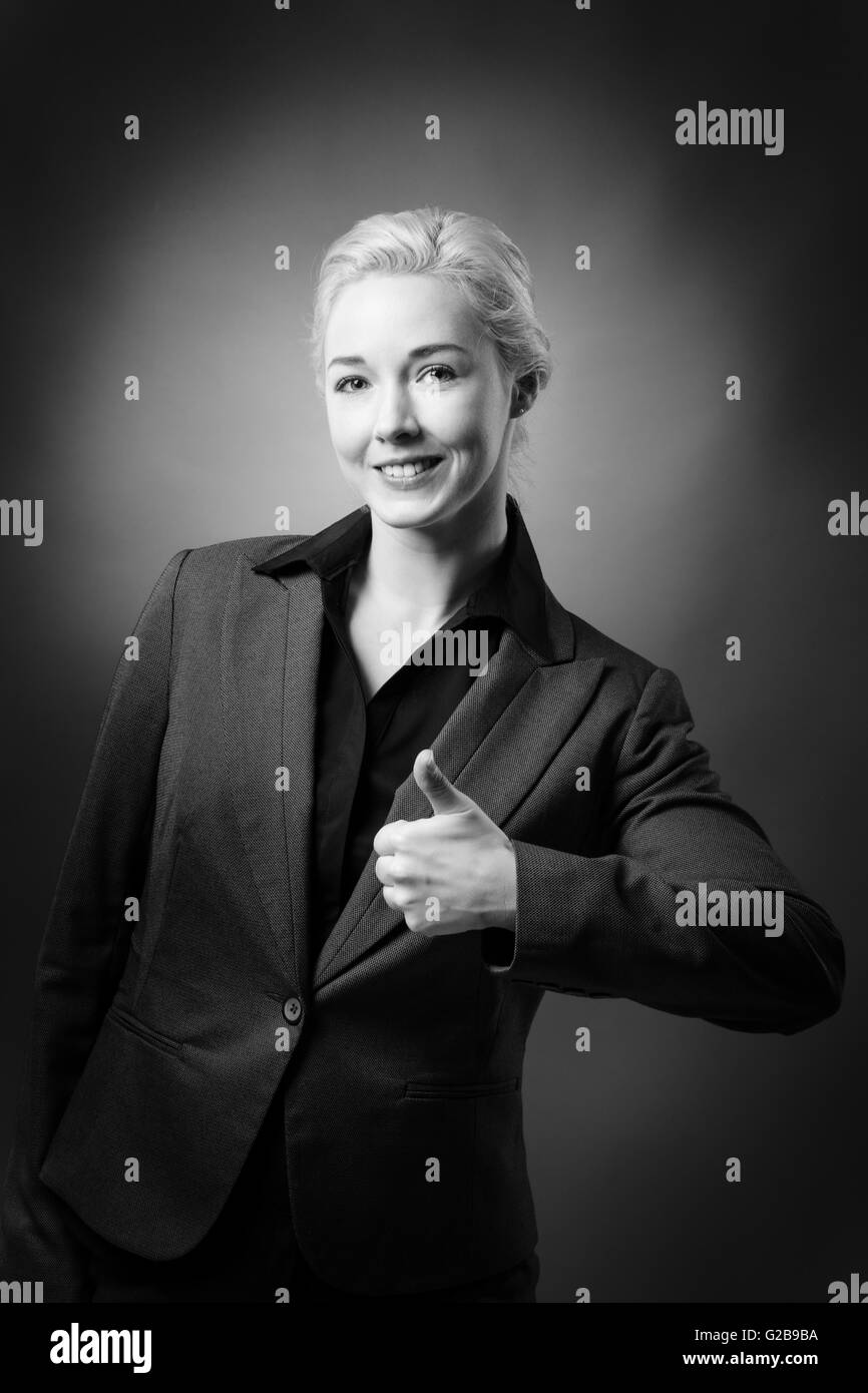 Studio shot of a business model making the thumbs up gesture, shot on a ...