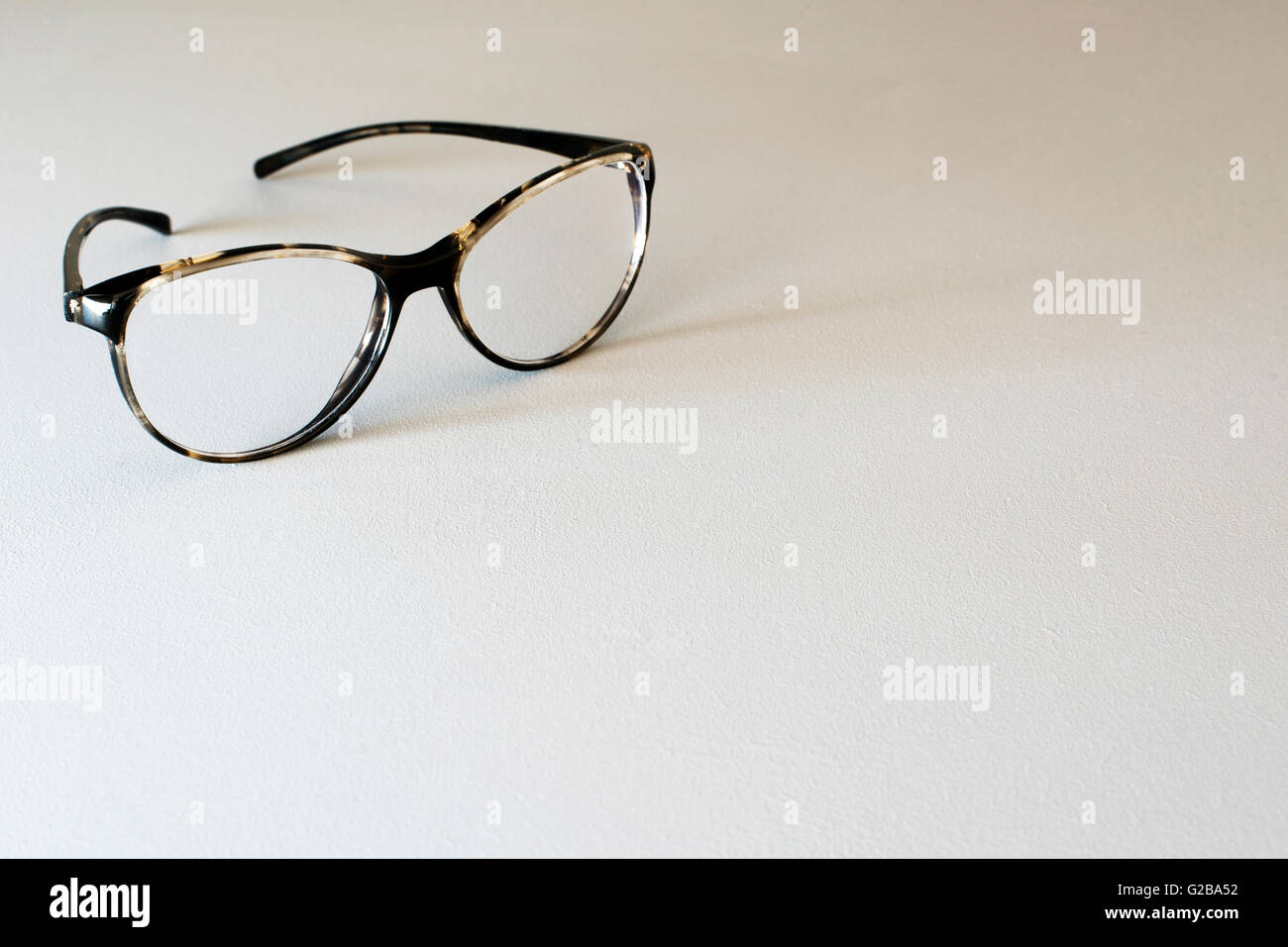 Spectacles on grey background Stock Photo - Alamy