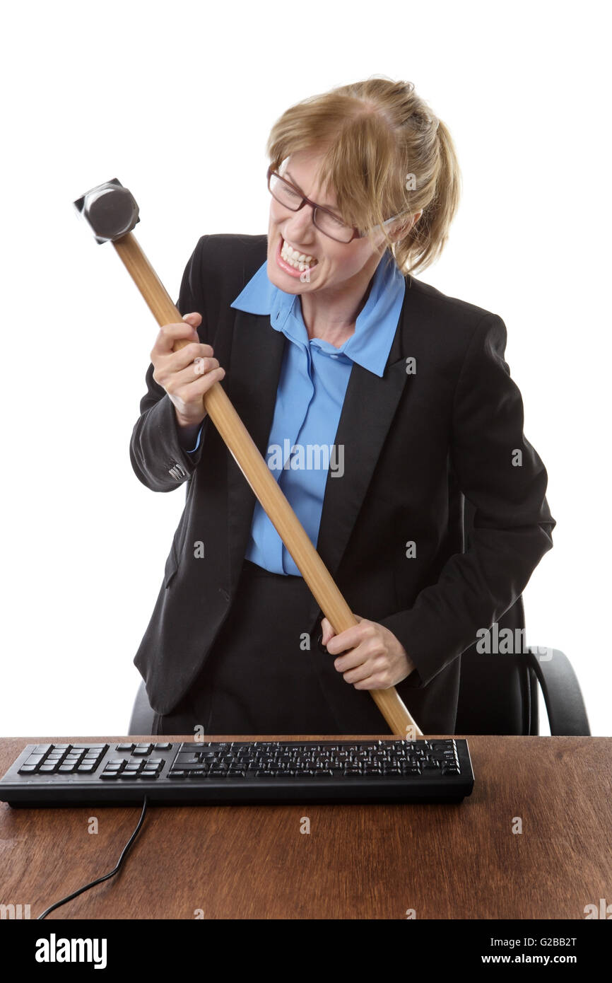 frustrated office worker is holding a sledgehammer, poised ready to ...