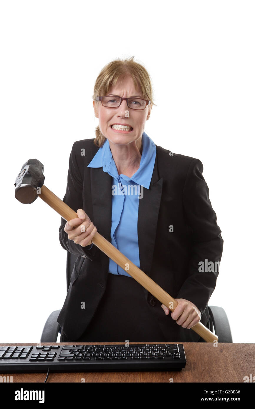 frustrated office worker is holding a sledgehammer, poised ready to ...