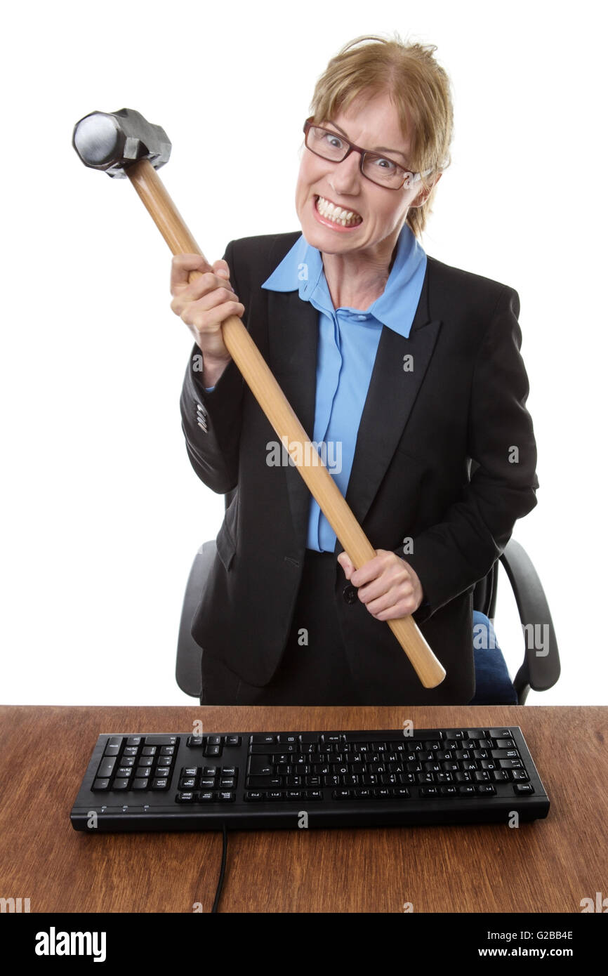 frustrated office worker is holding a sledgehammer, poised ready to ...