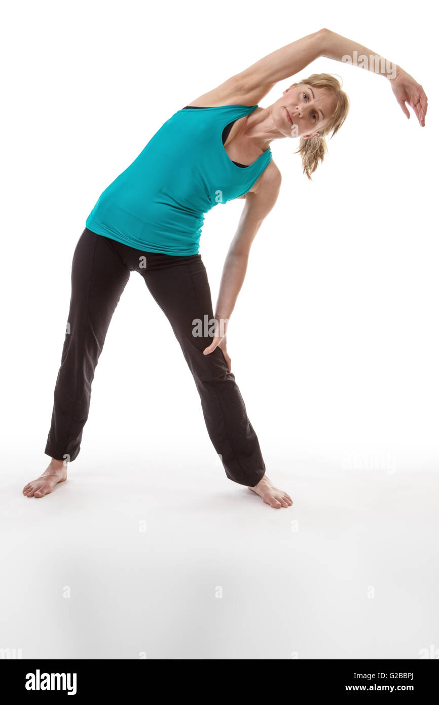 fitness model exercising, stretching the muscles of her arms and back ...