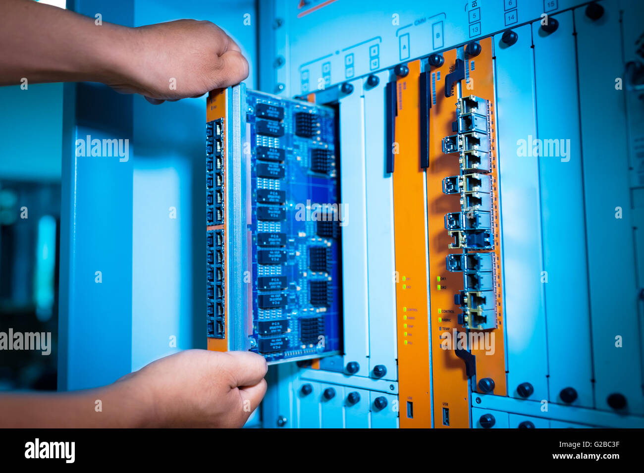 People fix core switch in network room Stock Photo - Alamy
