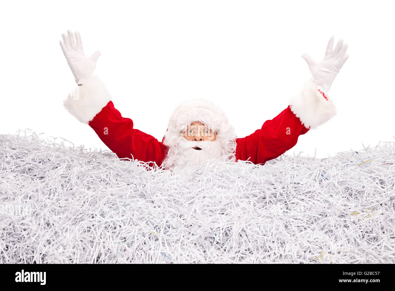 Studio shot of Santa Claus drowning in a pile of shredded paper ...