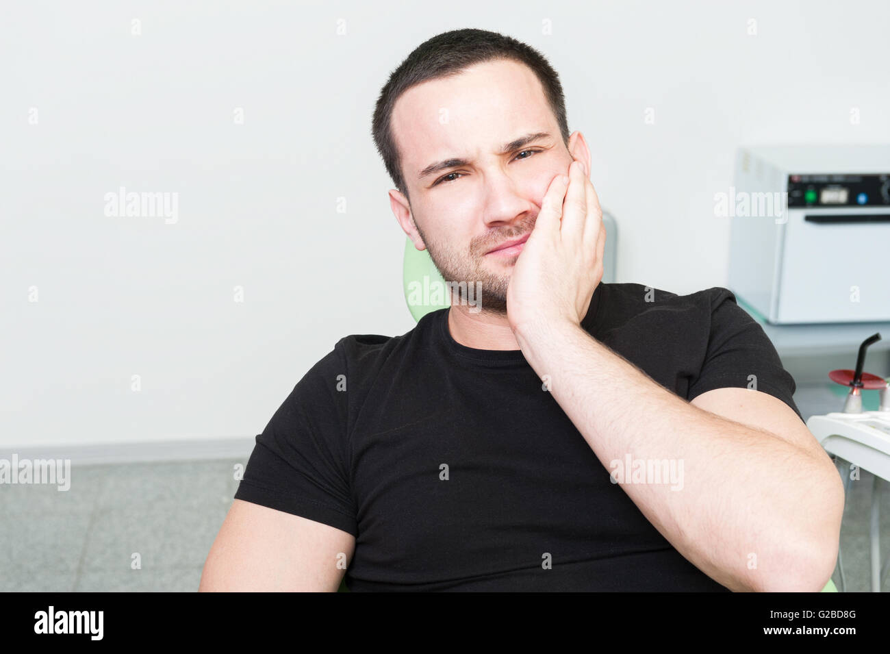Sad dentist patient suffering toothache and pressing his cheek Stock ...