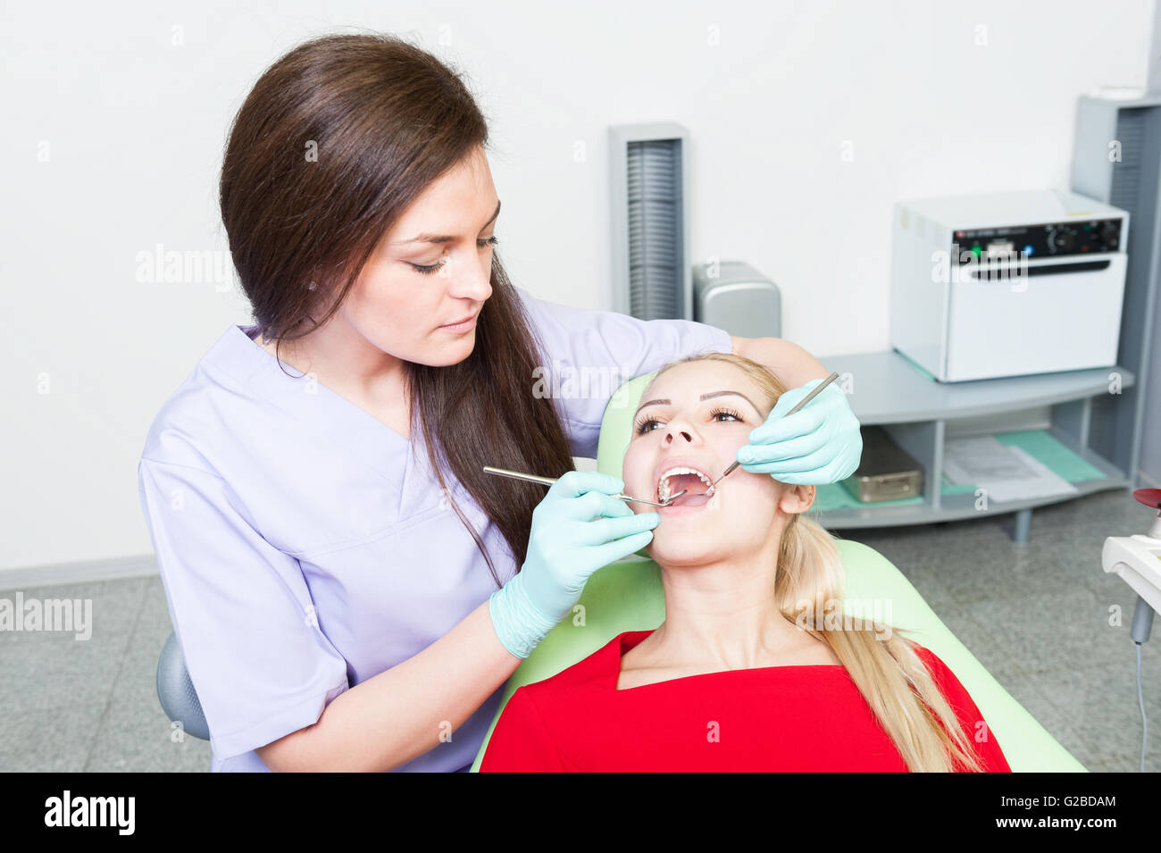 Female patient with open mouth at dentist as orthodontic exam concept ...