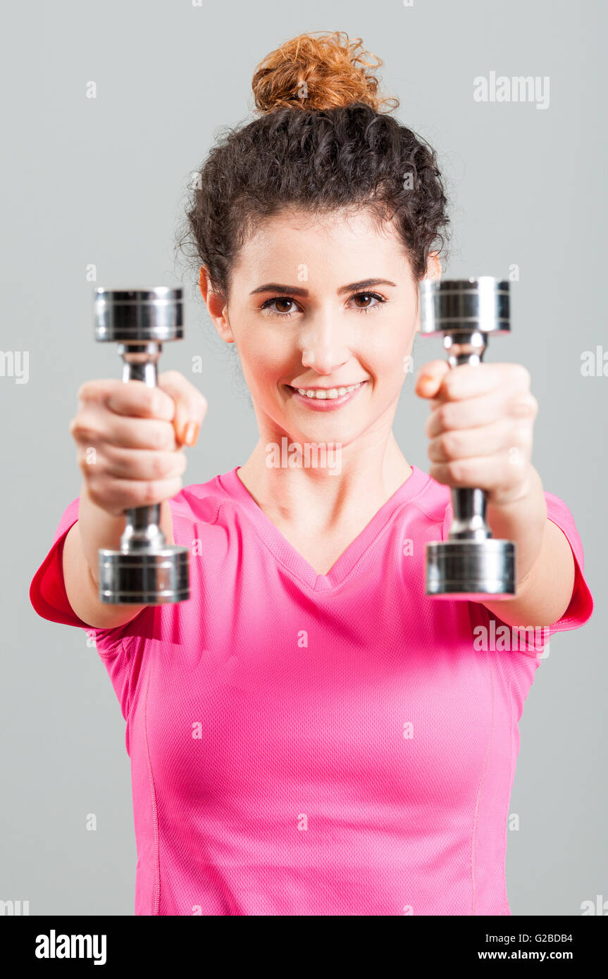 Woman doing fitness exercises using steel dumbbells as arms and ...