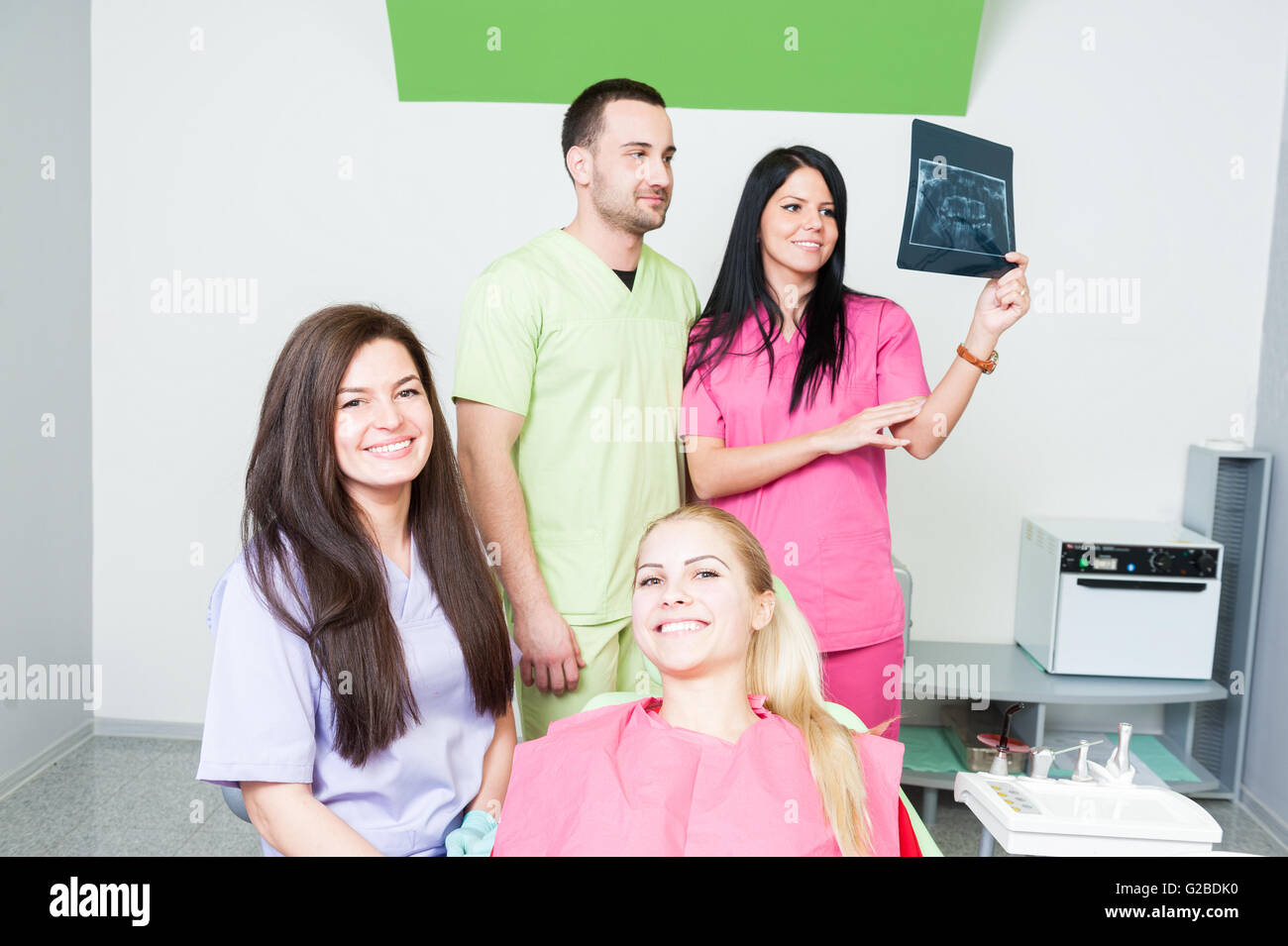 Professional dentist team and happy patient in dental office Stock ...