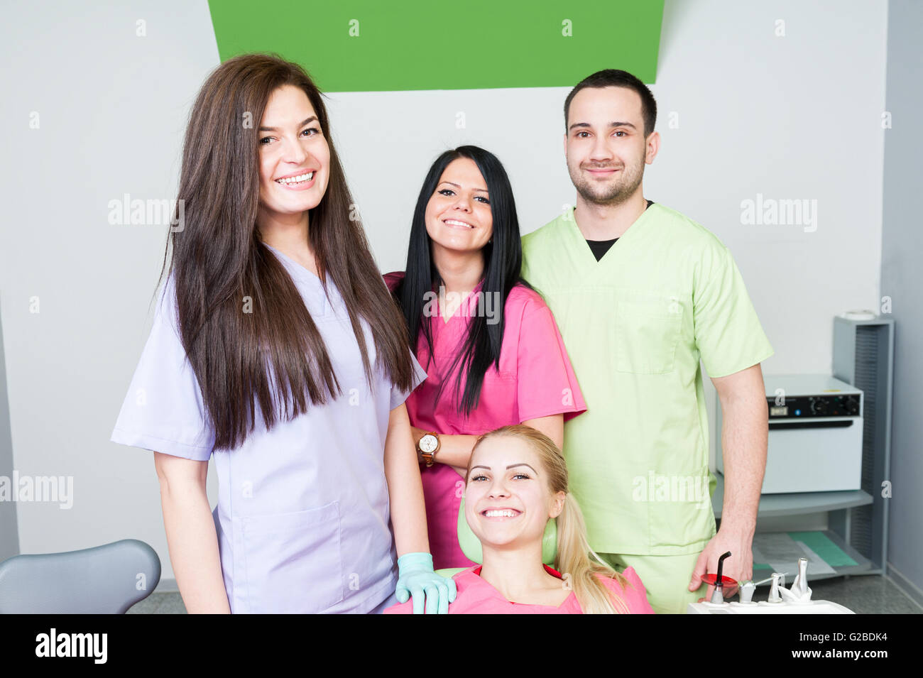 Dentist team and smiling patient in dental office Stock Photo - Alamy