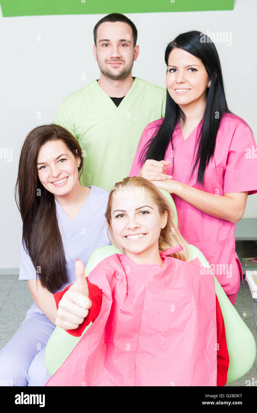 Happy patient and dental team in dentist office Stock Photo - Alamy