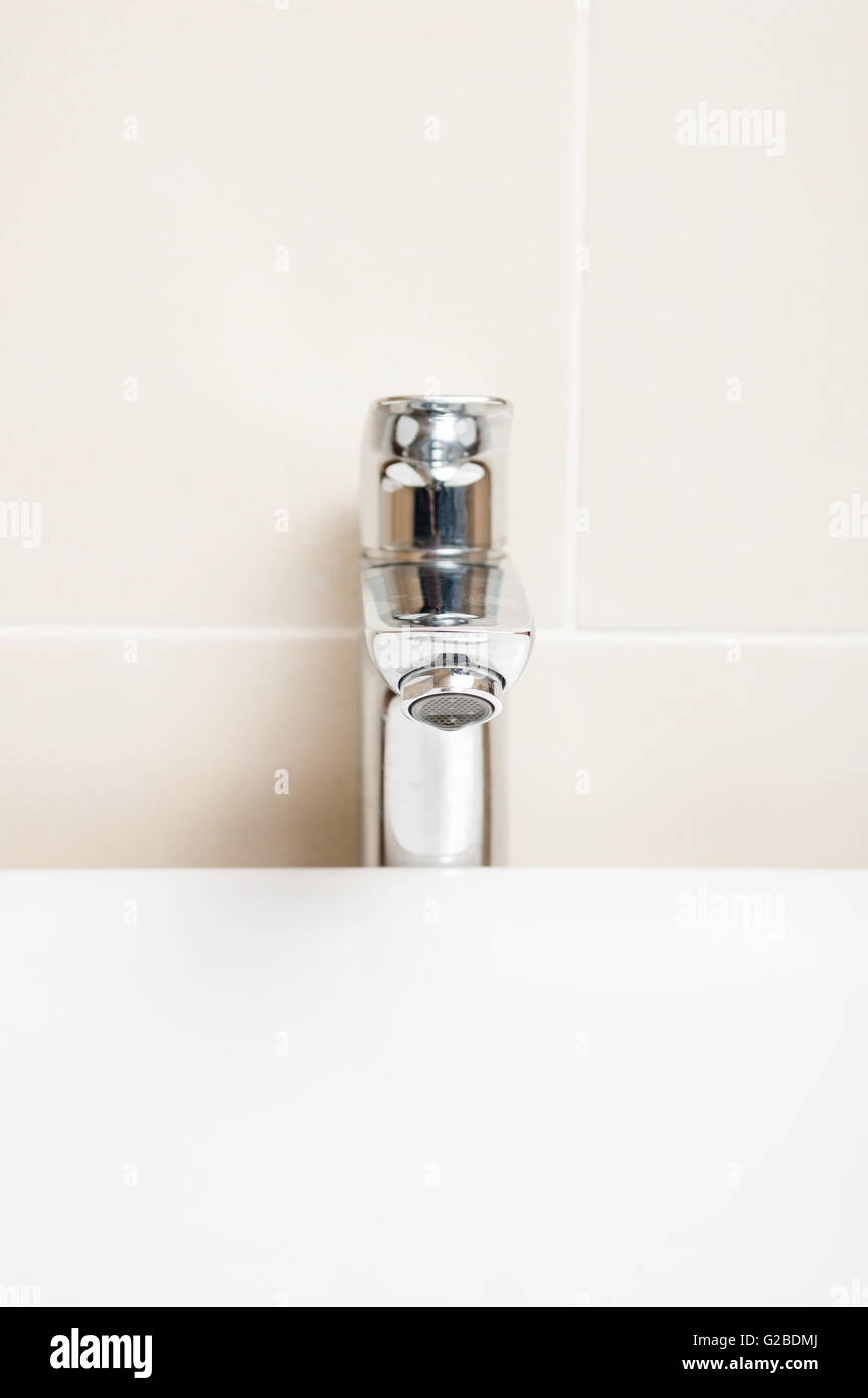 Front view of silver tap and white sink in a clean bathroom Stock Photo ...