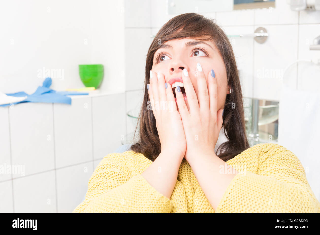 Close-up of woman with open mouth being scared of dentist and panic in ...