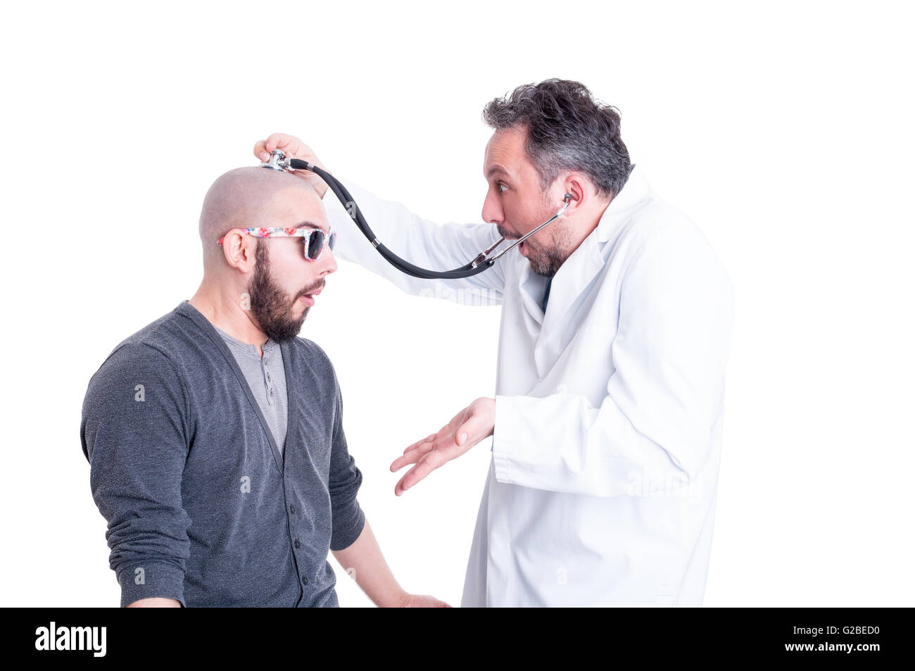 Young patient acting foolish during head examination on white ...