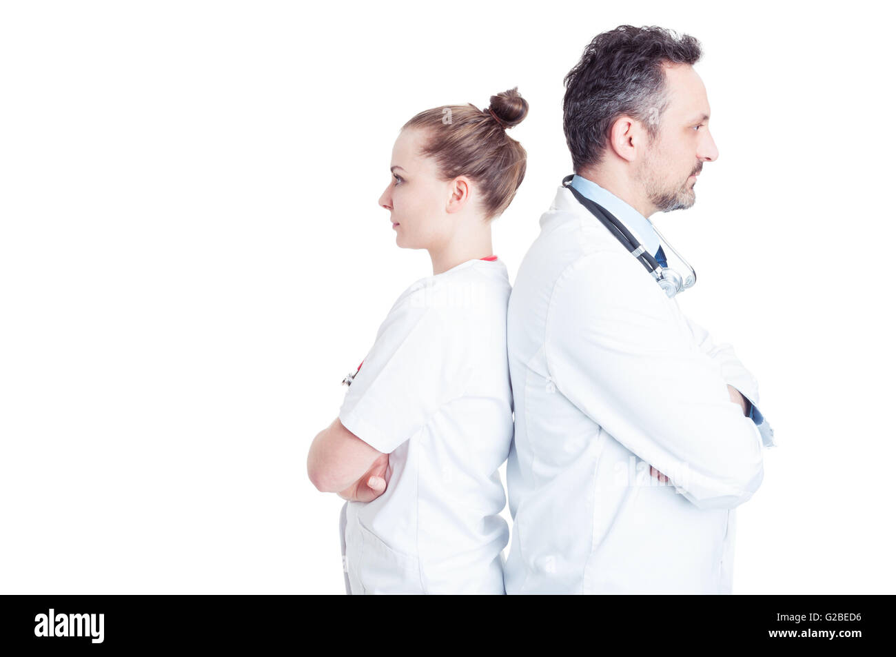 Portrait of two confident doctors standing back to back with crossed ...