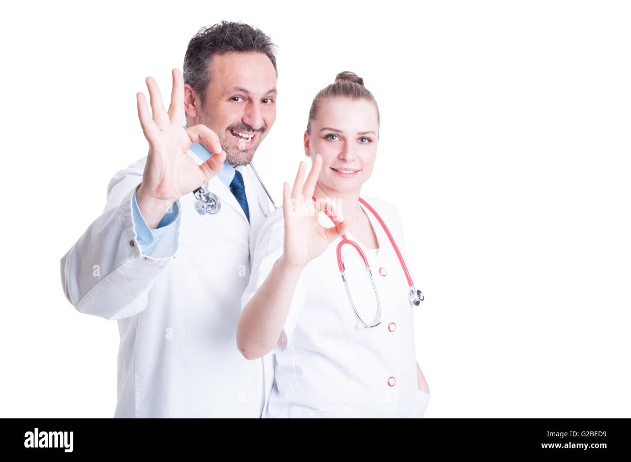 Friendly doctors acting confident and showing ok hand sign with ...